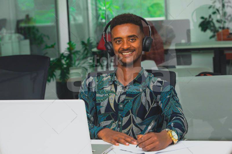 A Happy man at Work Place with Smile - StockAMBA.com