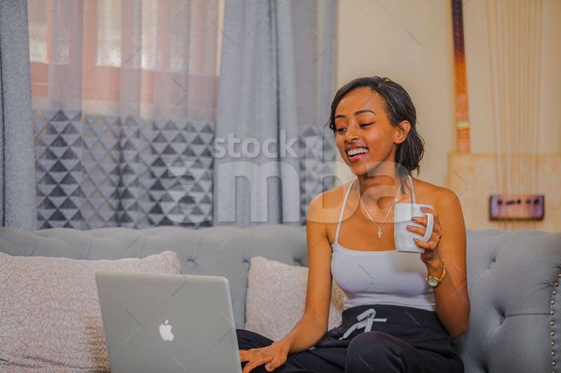 Woman Works with Computer at Home - StockAMBA.com