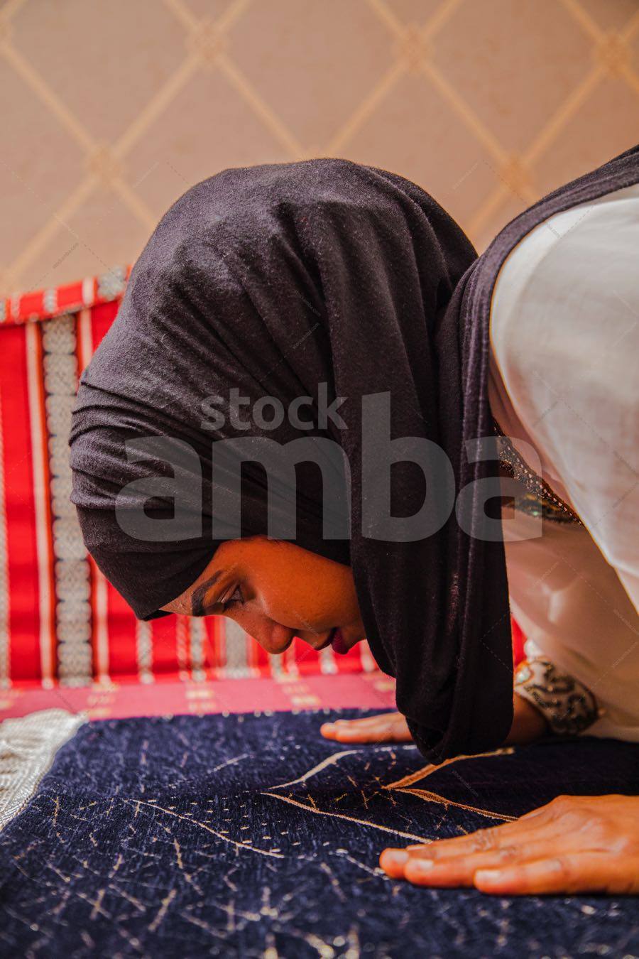 A Bowed Muslim Woman For The Daily Salat - StockAMBA.com