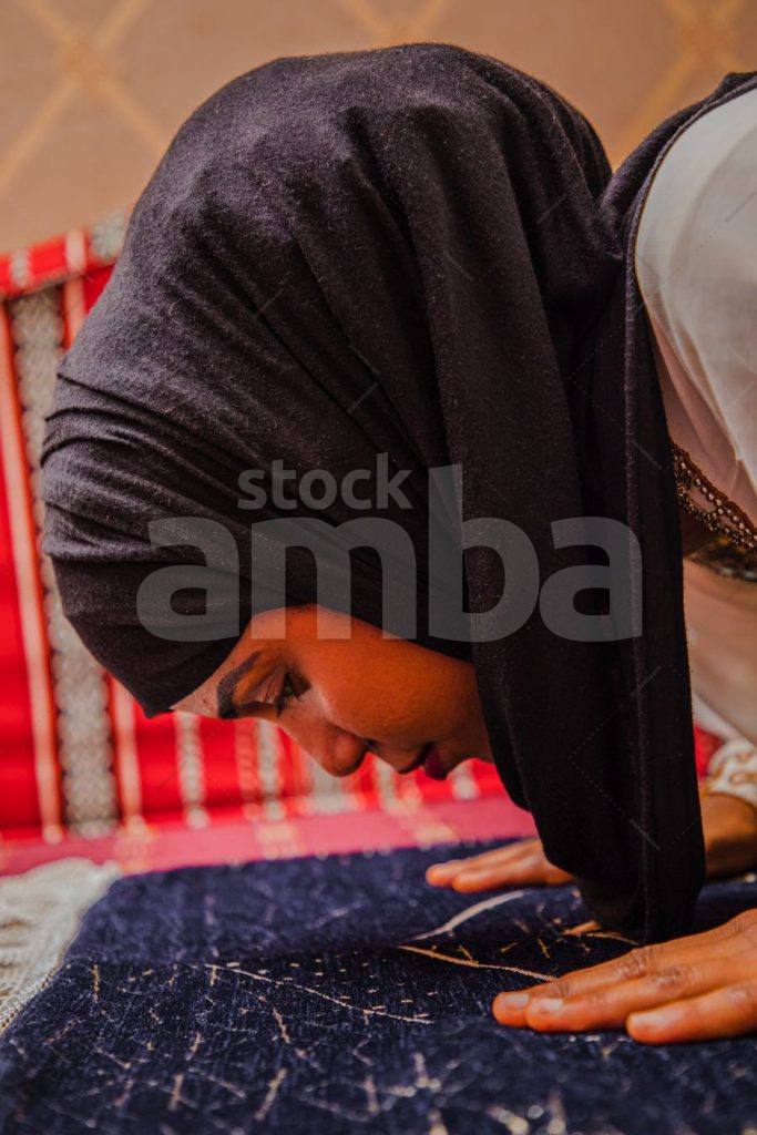 Gorgeous Muslim Woman Prostrating And Bowing For Salat - StockAMBA.com