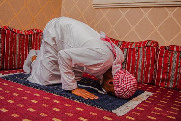 A Muslim Man Prostrating And Praying Daily Salat - StockAMBA.com
