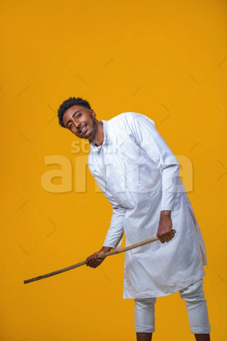 Happy Guy Posing For A Photoshoot Wearing White Outfit And Holding A ...